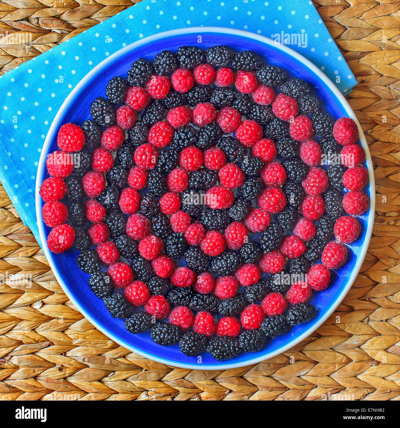 Colorful striped spiral of raspberry and mulberry on blue plate Stock ...