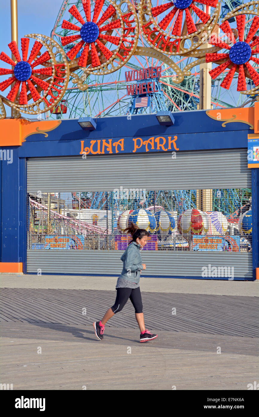 A runner on the boardwalk in Coney Island in Brooklyn, New York in the ...