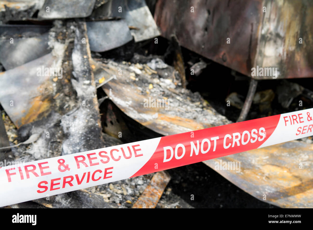Fire and Rescue Do Not Cross tape around burnt fire scene Stock Photo ...