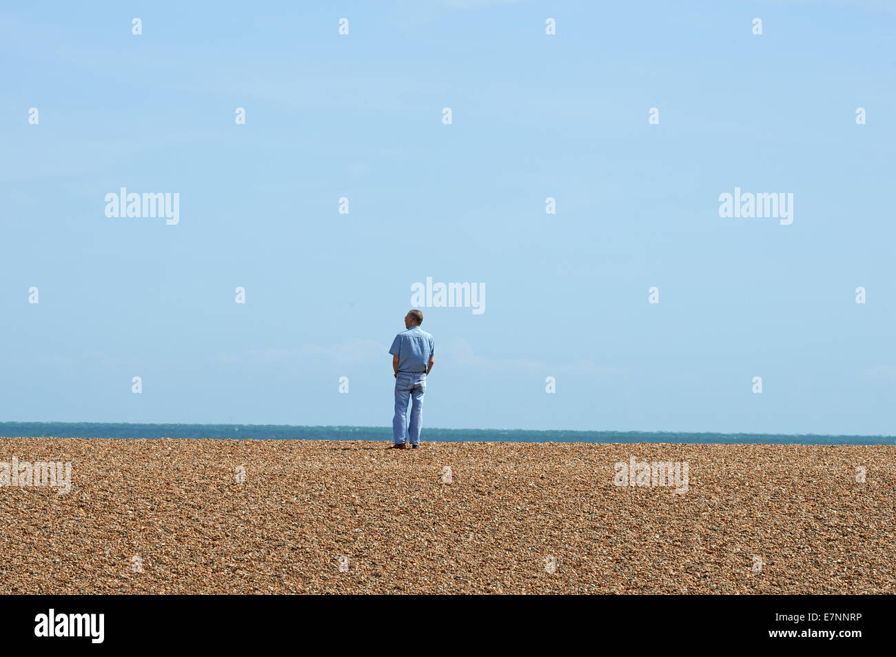 Man looking out to sea Stock Photo - Alamy