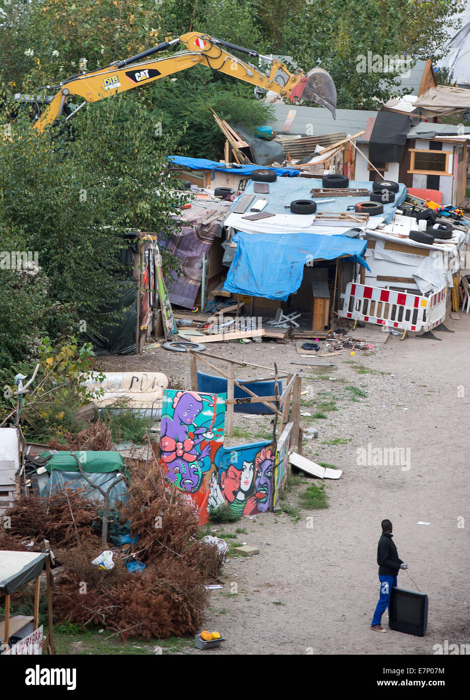 Berlin, Germany. 22nd Sep, 2014. An excavator demolishes makeshift huts ...
