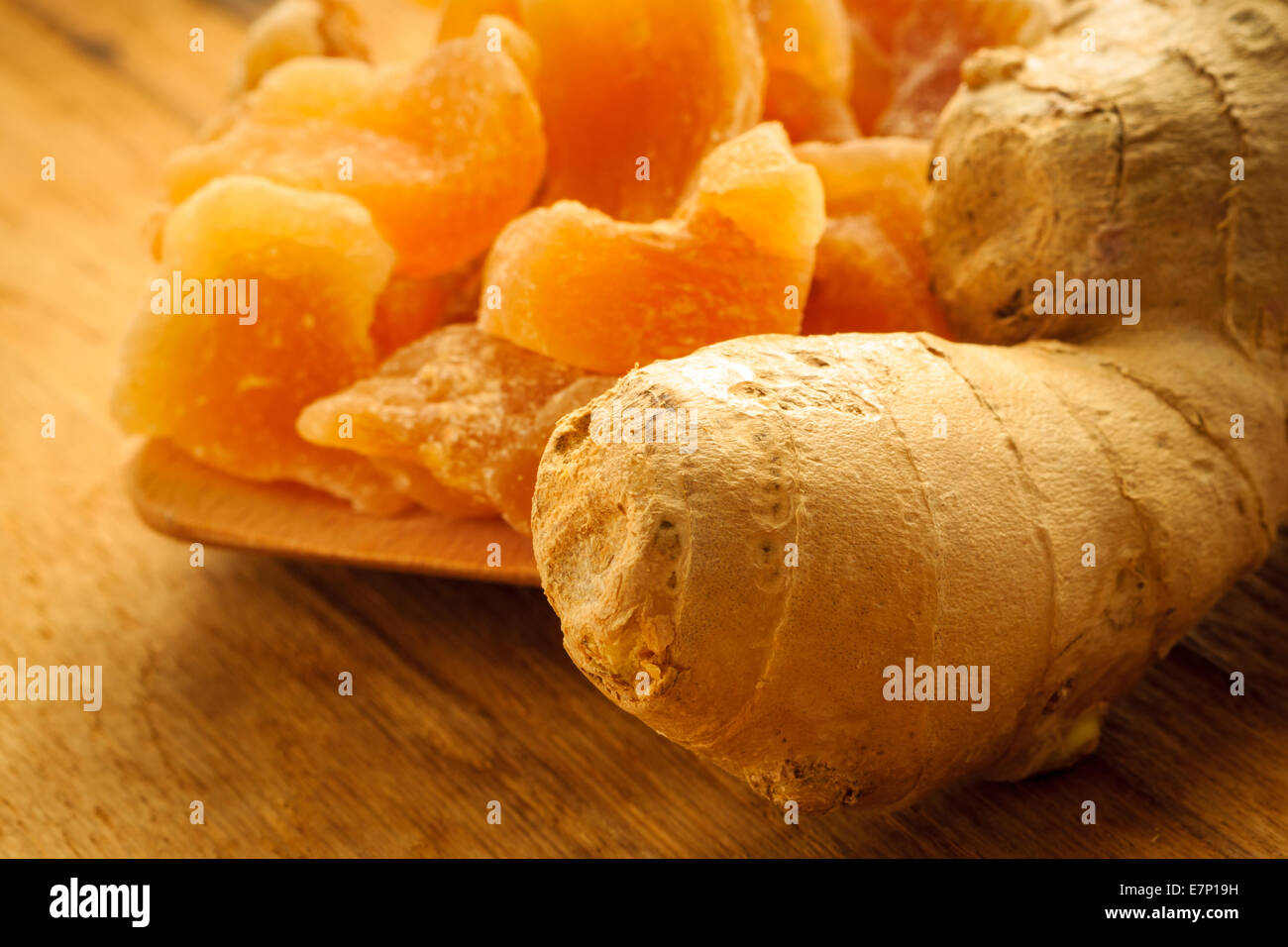 Closeup dried candied crystallized ginger pieces and fresh root on ...