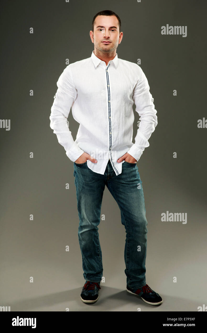 Full length portrait of a man standing over gray background Stock Photo ...
