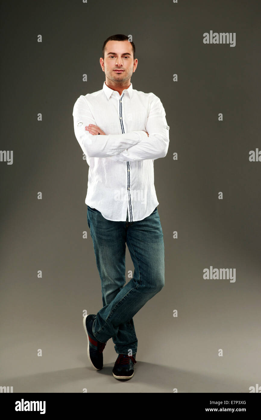 Full length portrait of a man standing over gray background Stock Photo ...