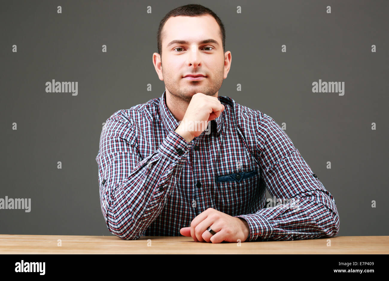 Portrait of happy man sitting at the table Stock Photo - Alamy