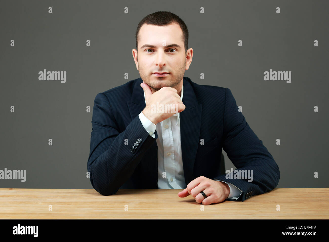 Portrait serious boss sitting table hi-res stock photography and images ...