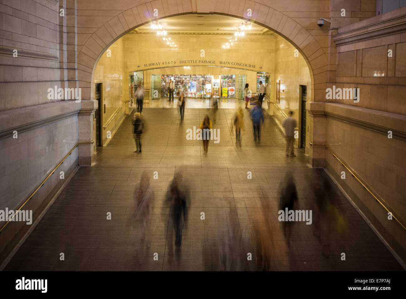 Travelers ascend and descend the ramp leading to and from the lower ...