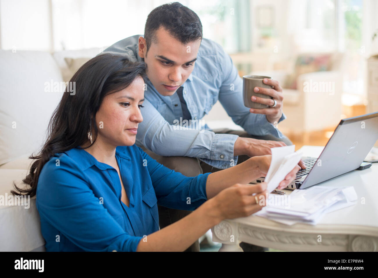 Couple working in living room Stock Photo - Alamy