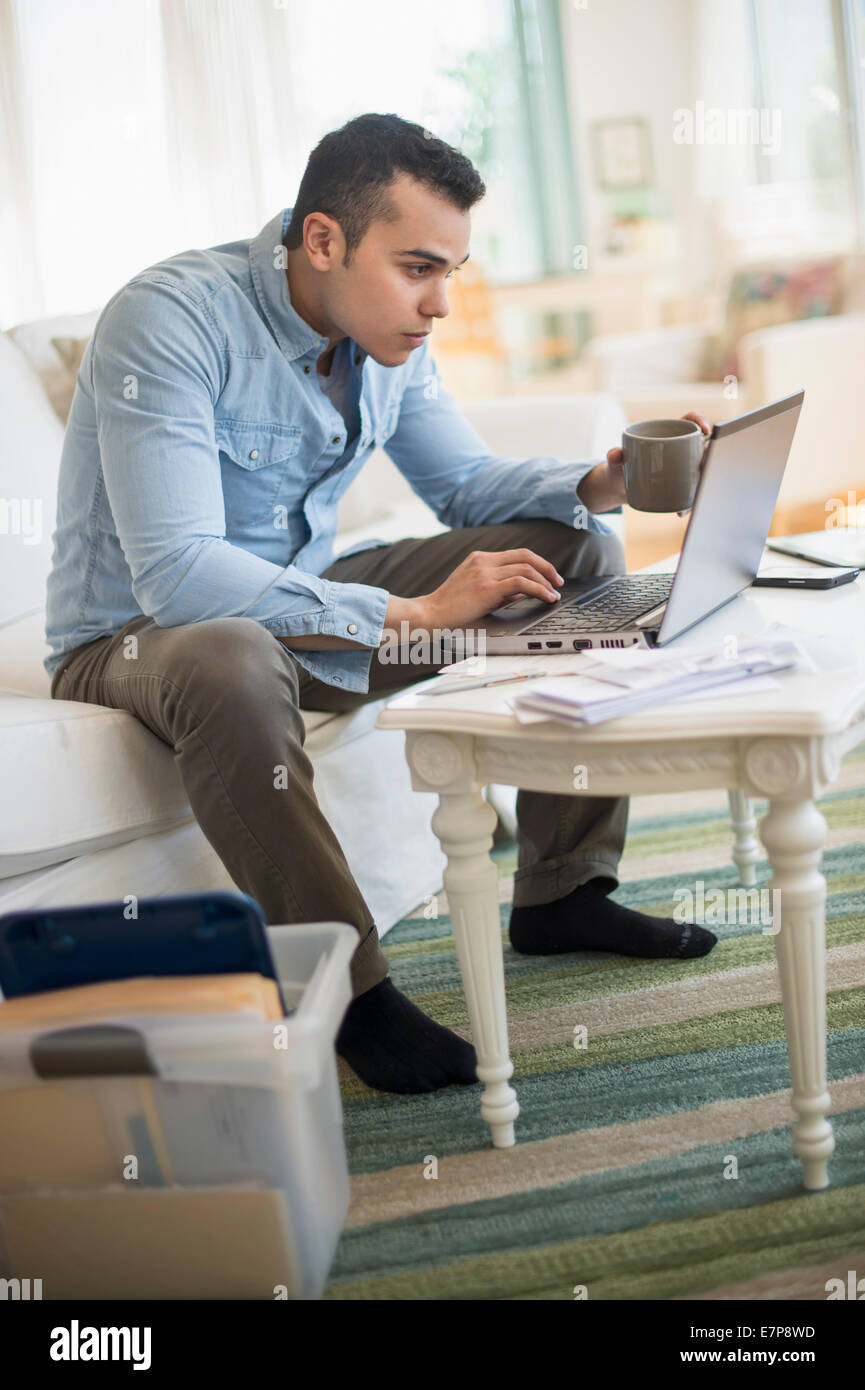 Man working in living room Stock Photo - Alamy