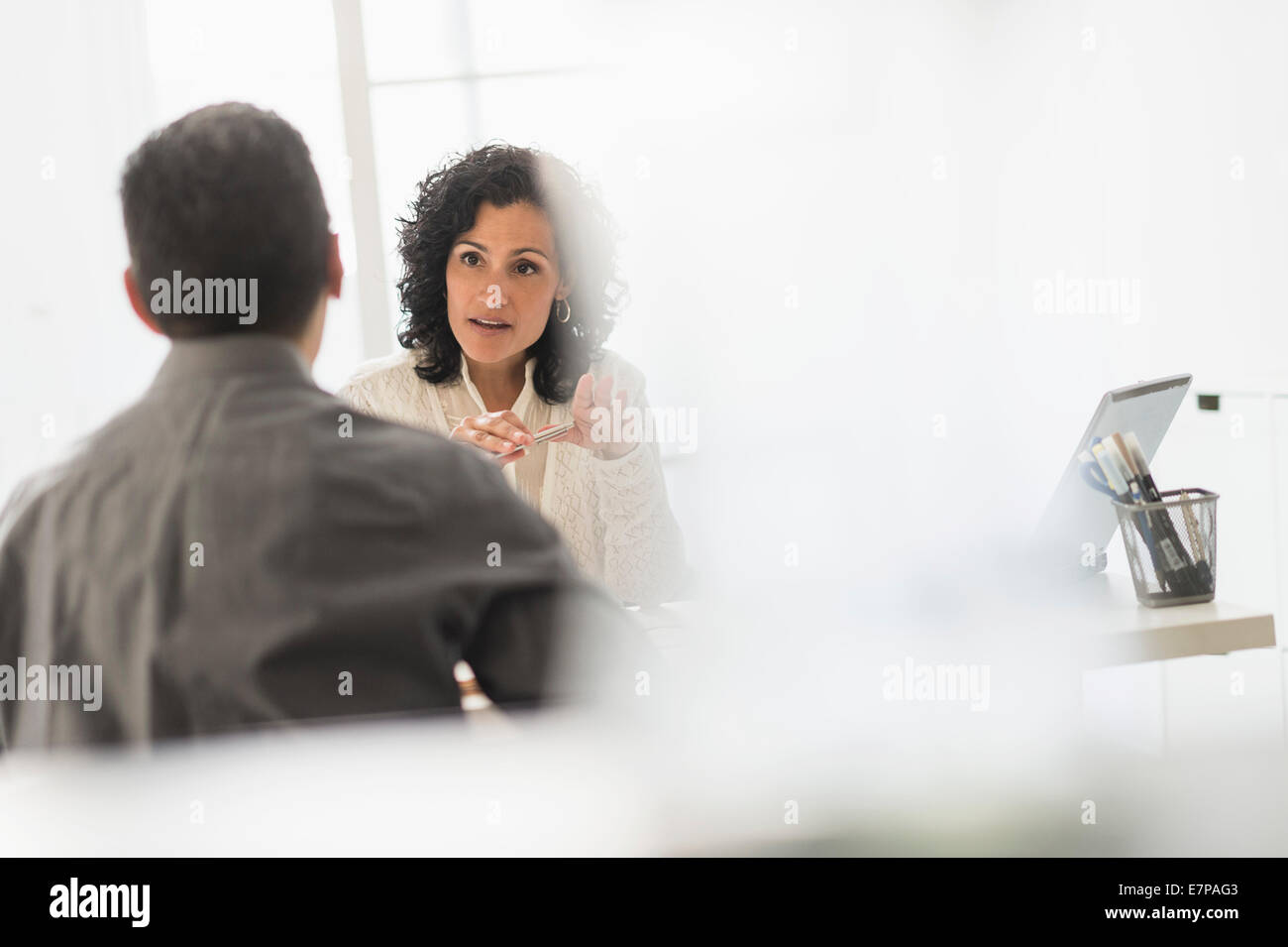 Business people talking at desk in office Stock Photo - Alamy