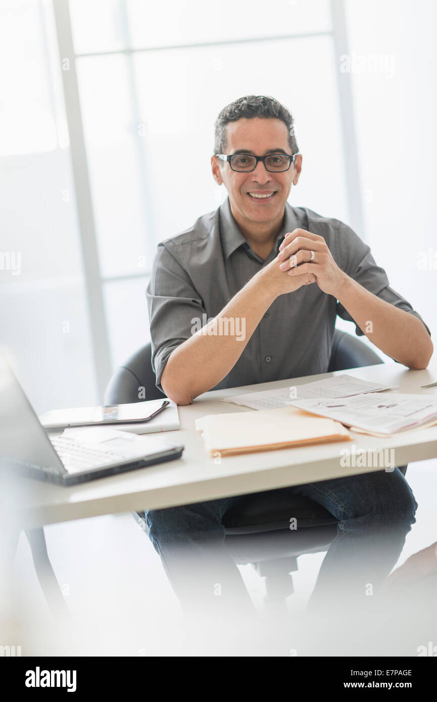 Portrait of man at desk in office Stock Photo - Alamy