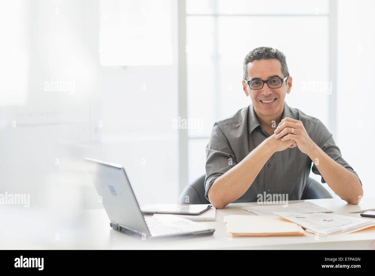 Portrait of man at desk in office Stock Photo - Alamy