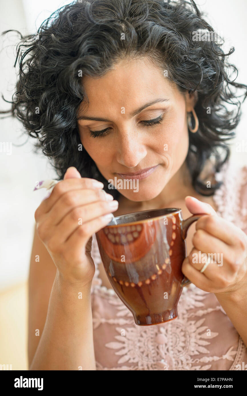 Woman enjoying her tea Stock Photo - Alamy