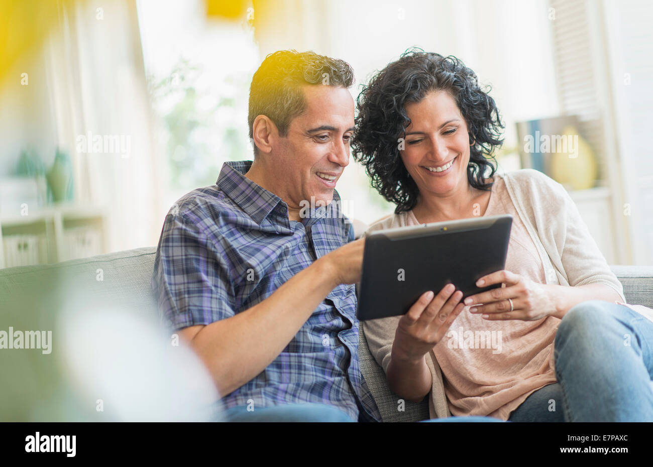 Couple using digital tablet together Stock Photo - Alamy