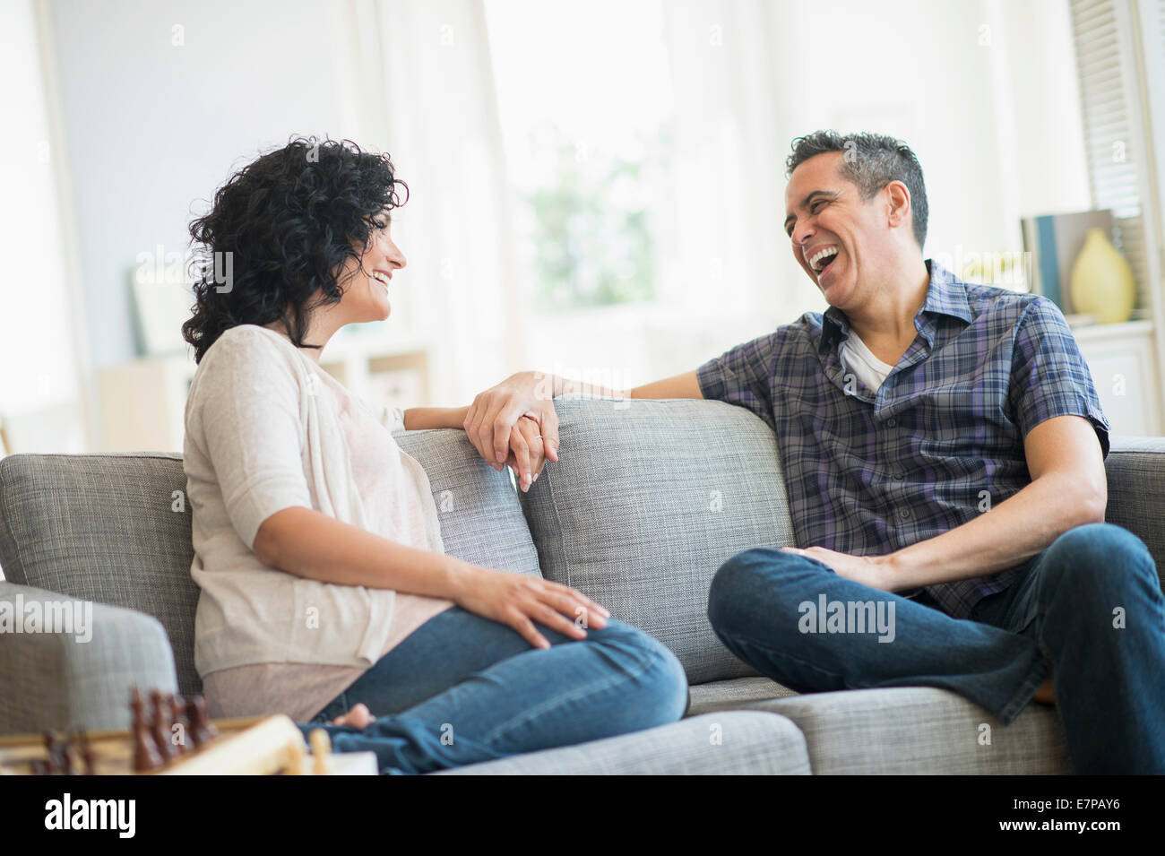 Couple talking on sofa Stock Photo - Alamy