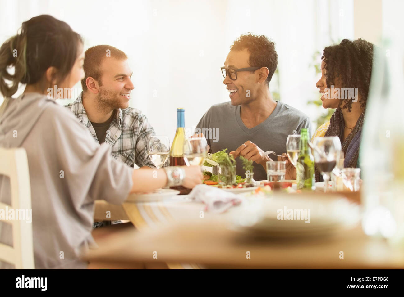 Young friends laughing dinner hi-res stock photography and images - Alamy