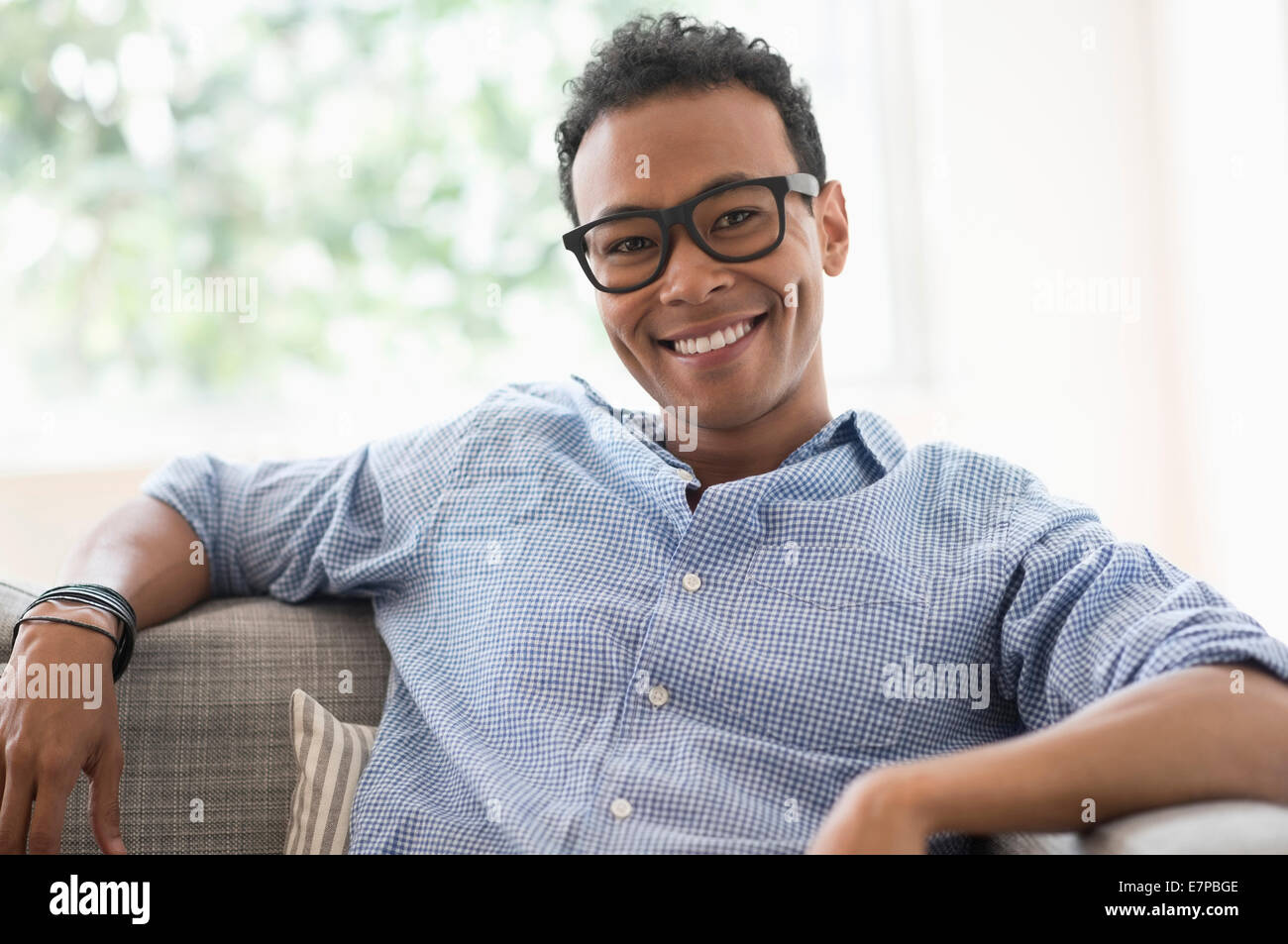 Portrait of young relaxed man smiling Stock Photo - Alamy