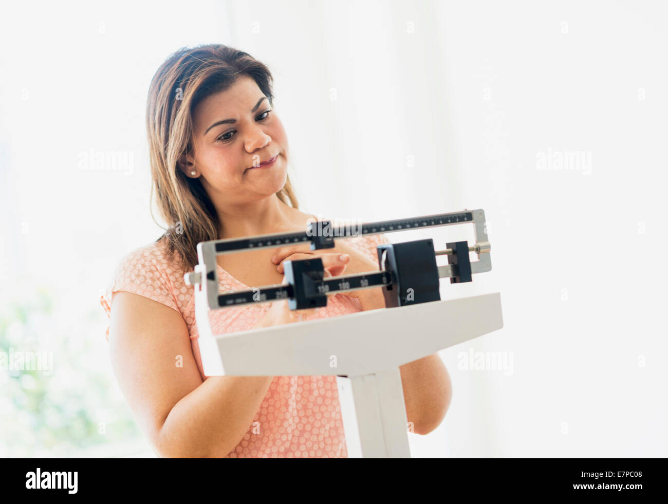 Woman standing on scale Stock Photo - Alamy