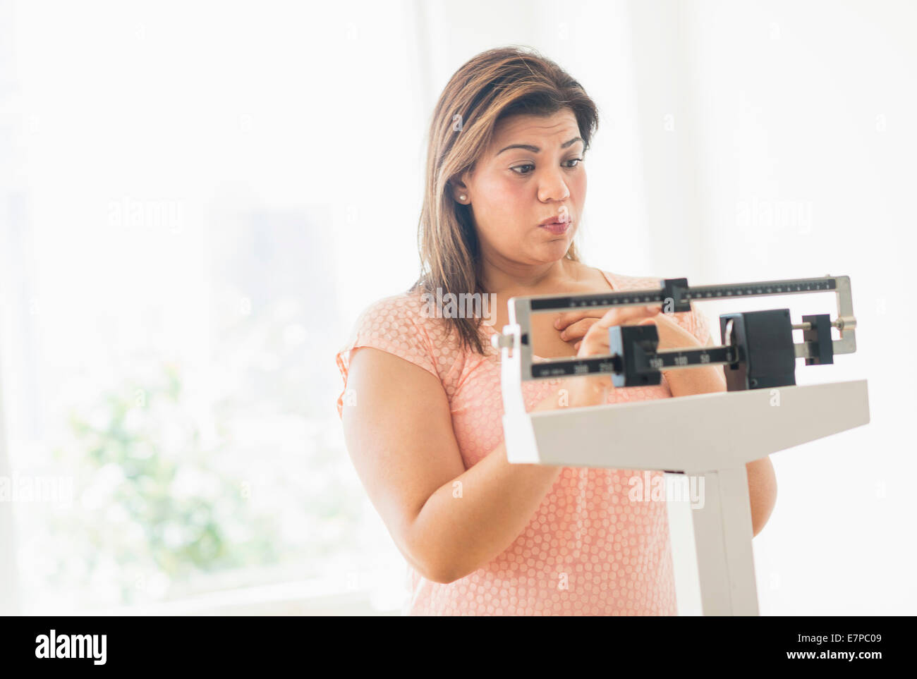Woman standing on scale Stock Photo - Alamy