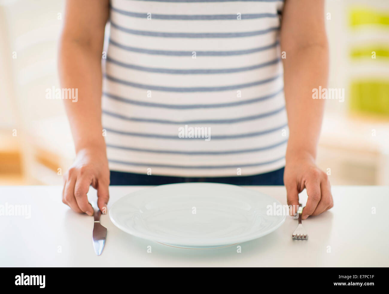 Woman standing by table Stock Photo - Alamy