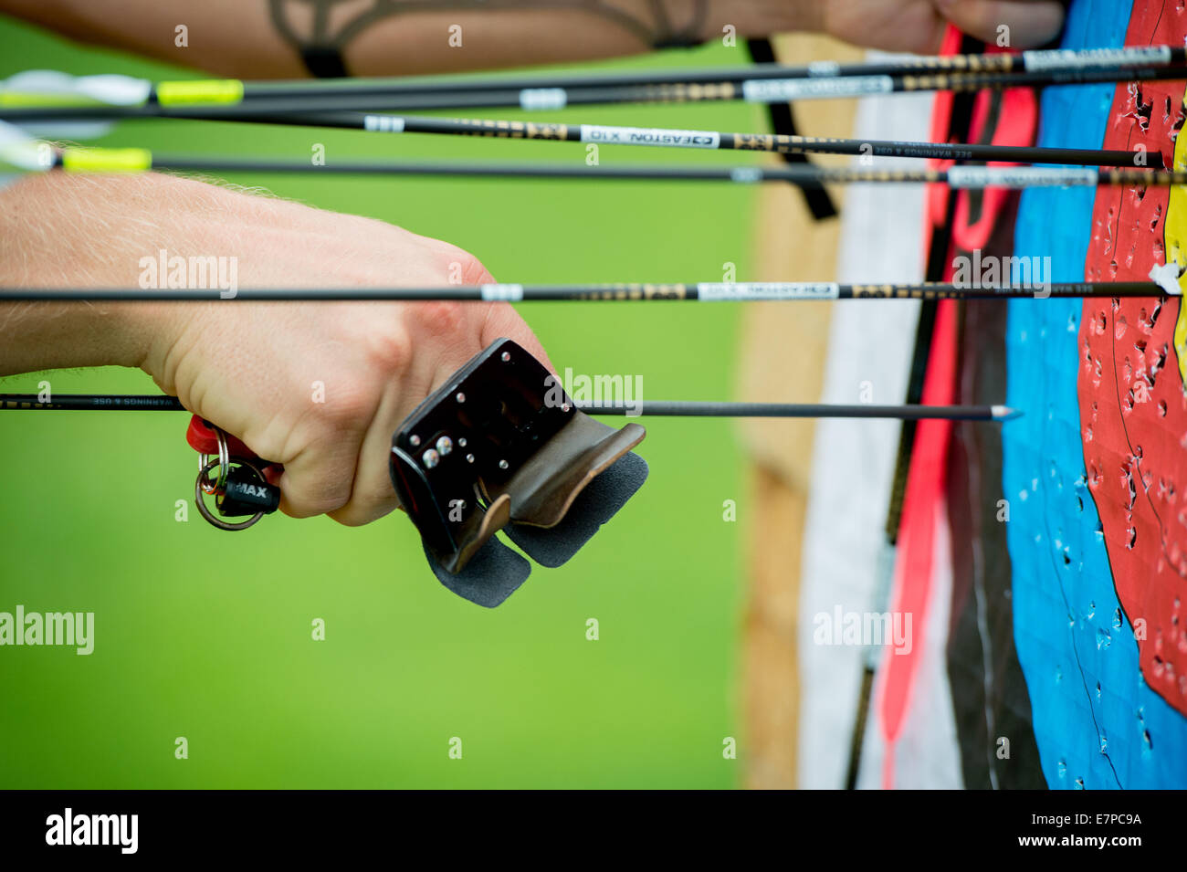 The Archer is pulling the arrows out of the target using a special kind ...