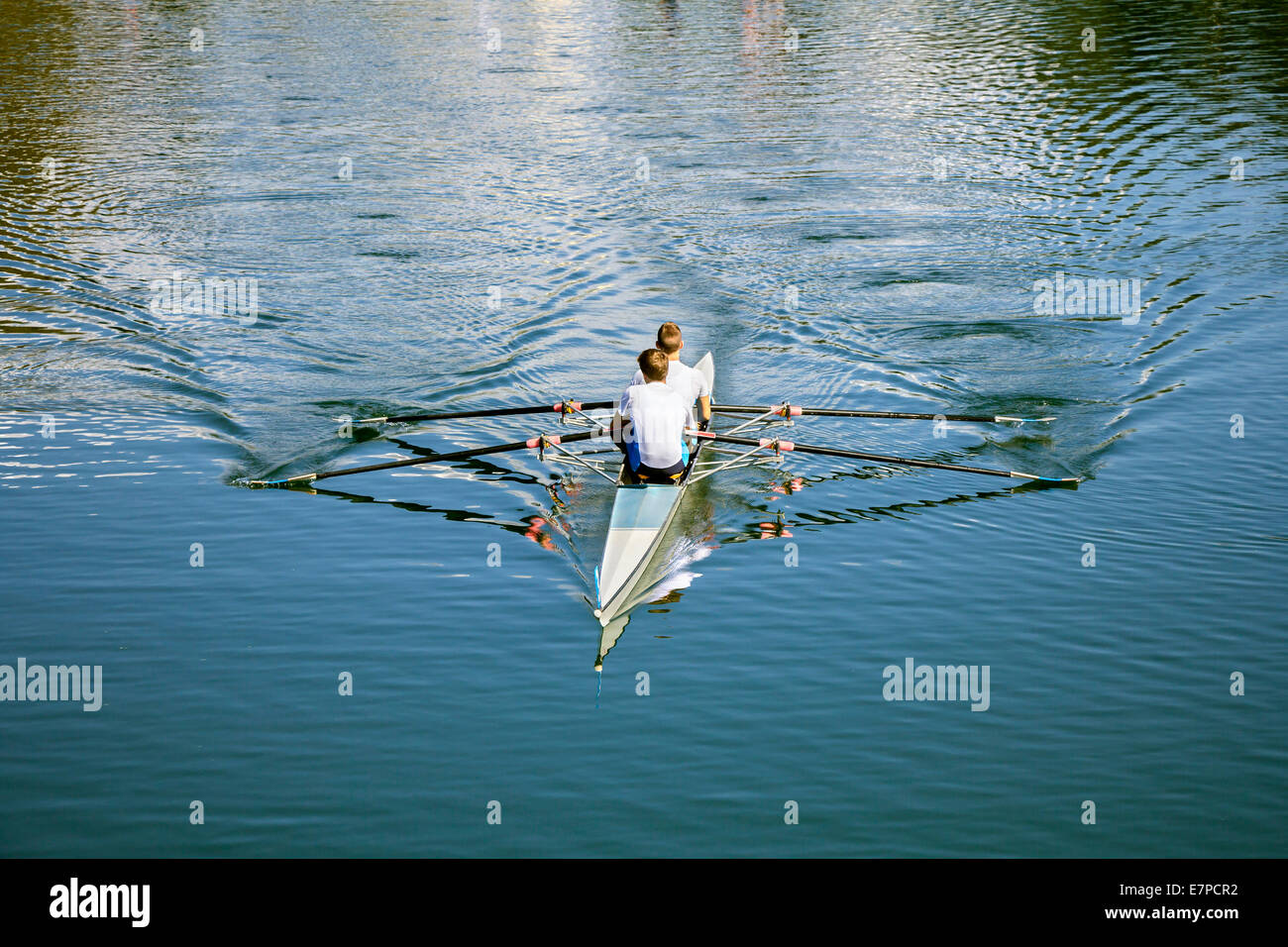Two rowers in a boat, rowing on the tranquil lake Stock Photo - Alamy