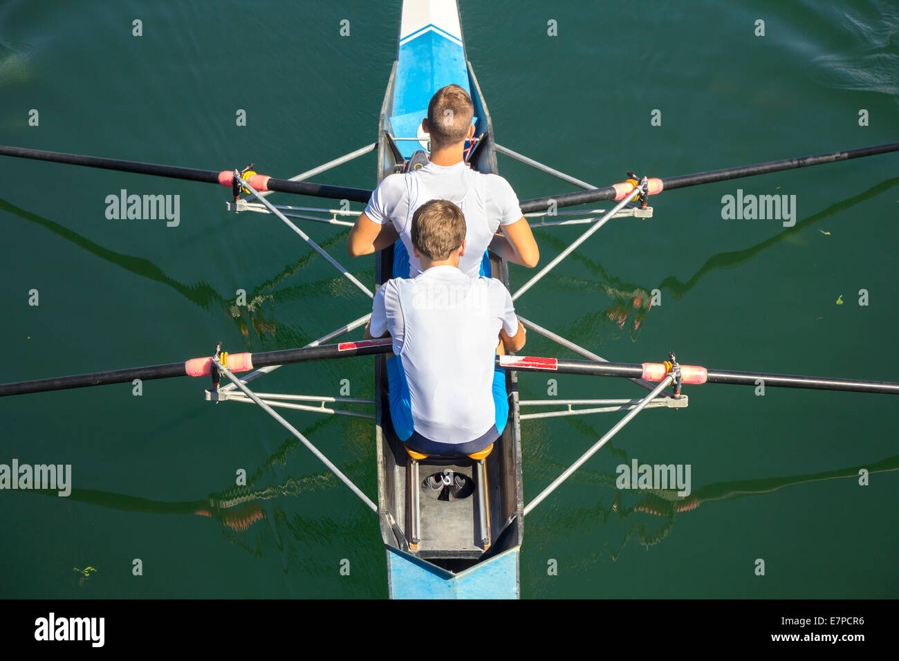 Two rowers in a boat, rowing on the tranquil lake Stock Photo - Alamy