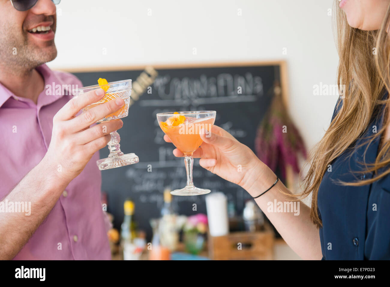 Couple toasting at party Stock Photo - Alamy