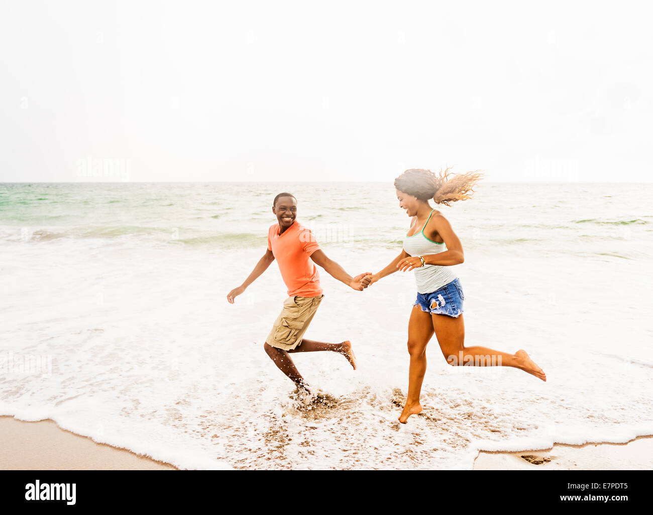 Young excited couple running hi-res stock photography and images - Alamy