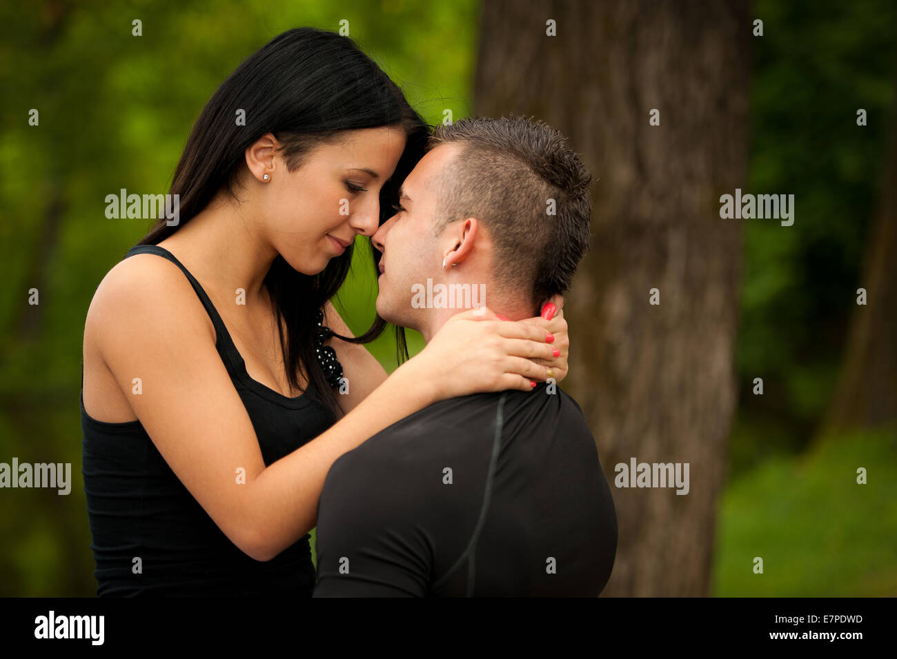 Teenage couple on a late summer afternoon in park Stock Photo - Alamy