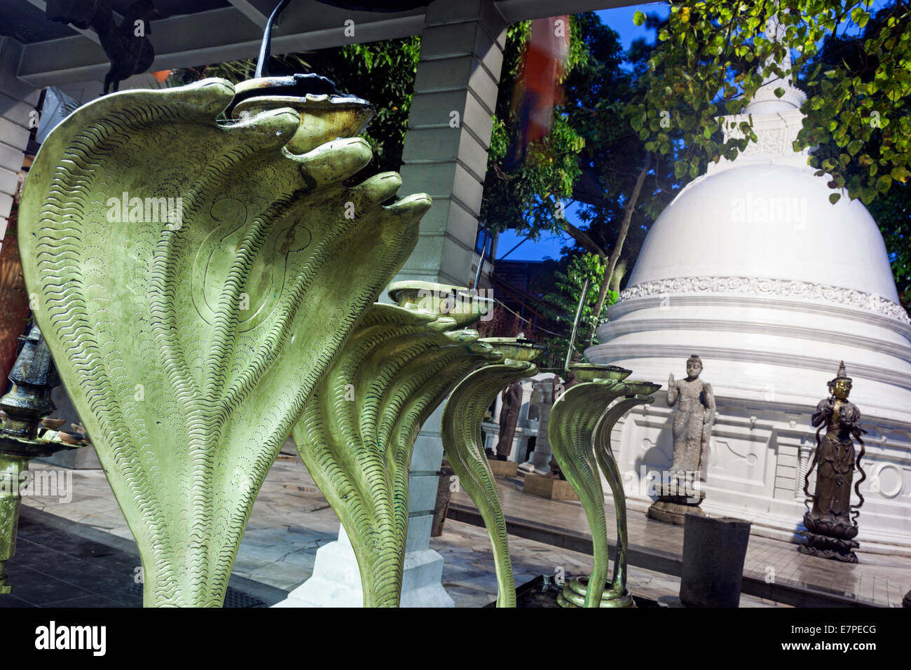 Sri Lanka, Colombo, Cobra statues in front of stupa in Gangaramaya ...