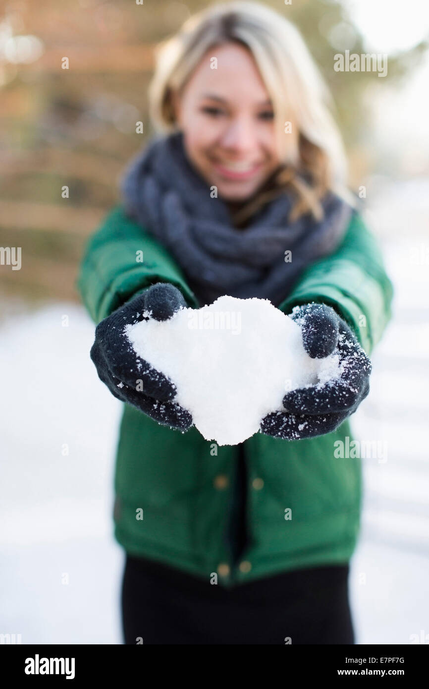 Woman holding snowball Stock Photo - Alamy