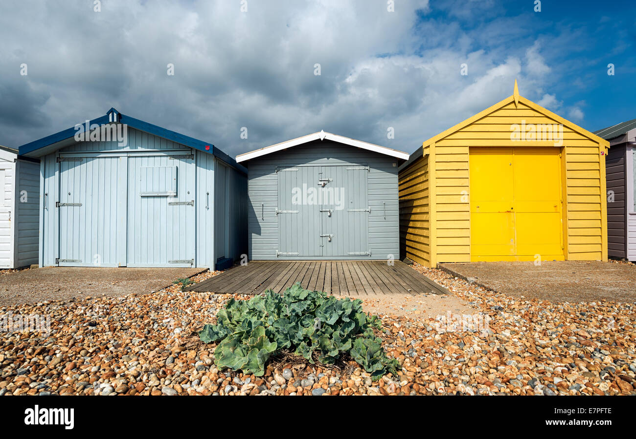 A row of beach huts on a shingle beach at St Leonards on Sea in ...