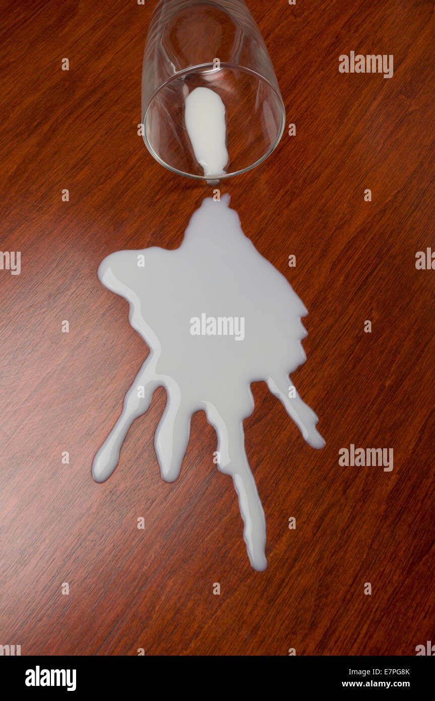 Spilled glass of milk Stock Photo - Alamy