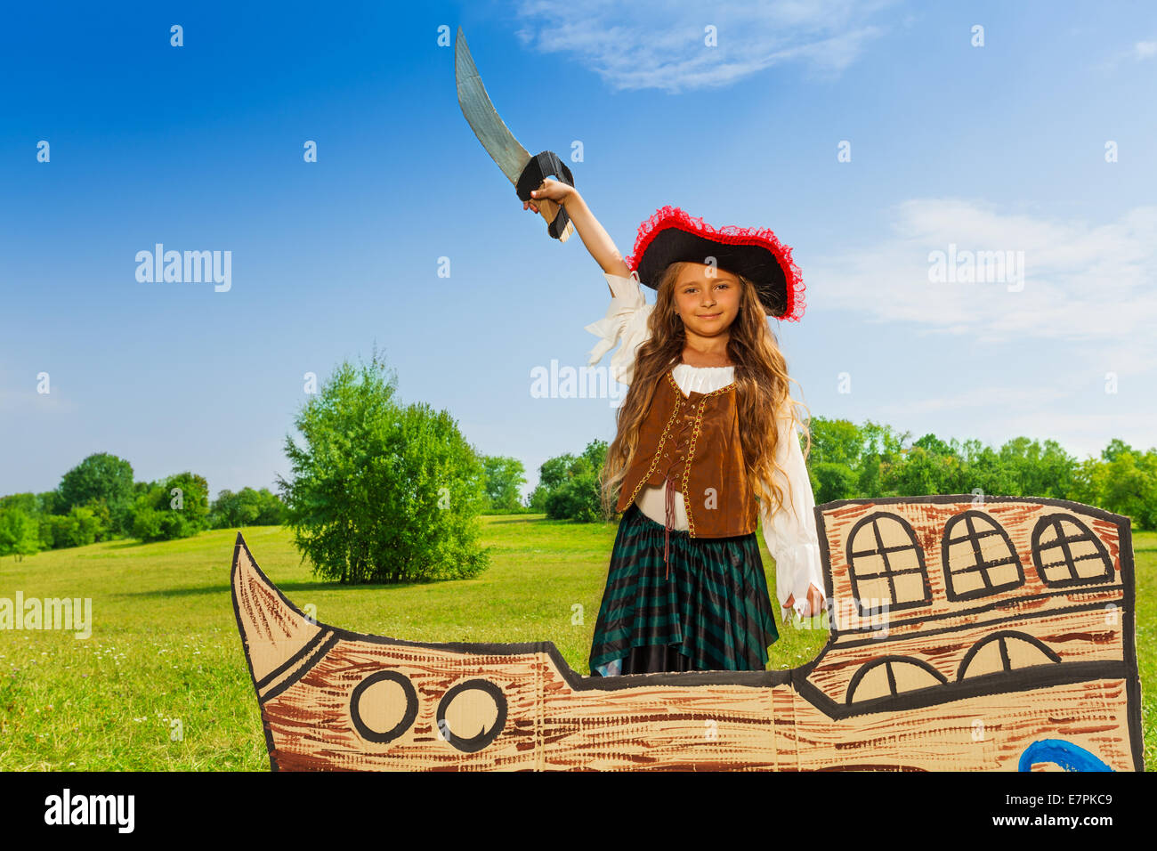 Girl in pirate costume stand on ship with sword Stock Photo - Alamy