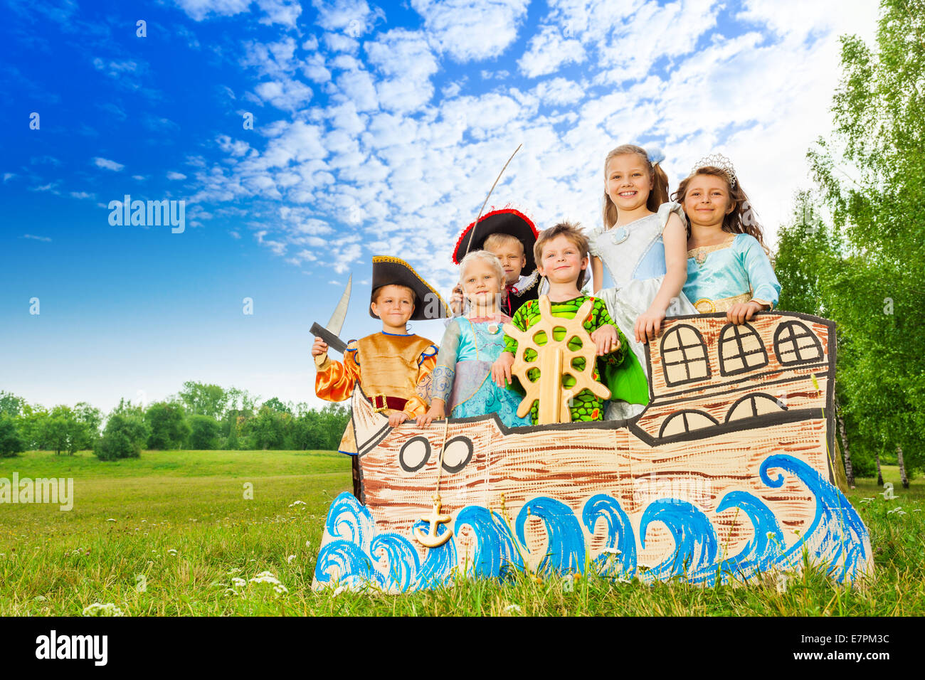 Happy children in costumes standing on ship Stock Photo - Alamy