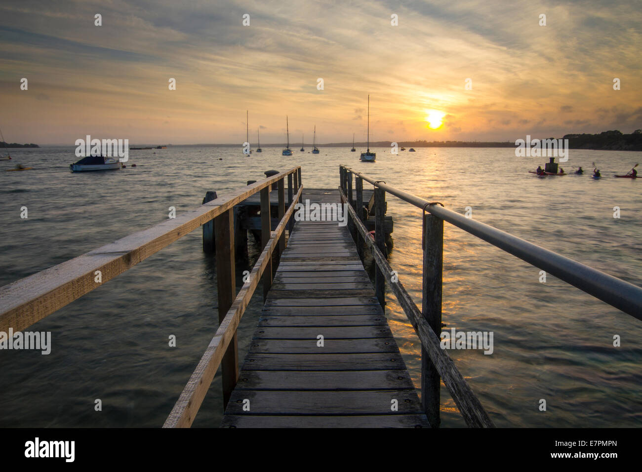 Long exposure seascape down a pier overlooking Poole with boats and ...