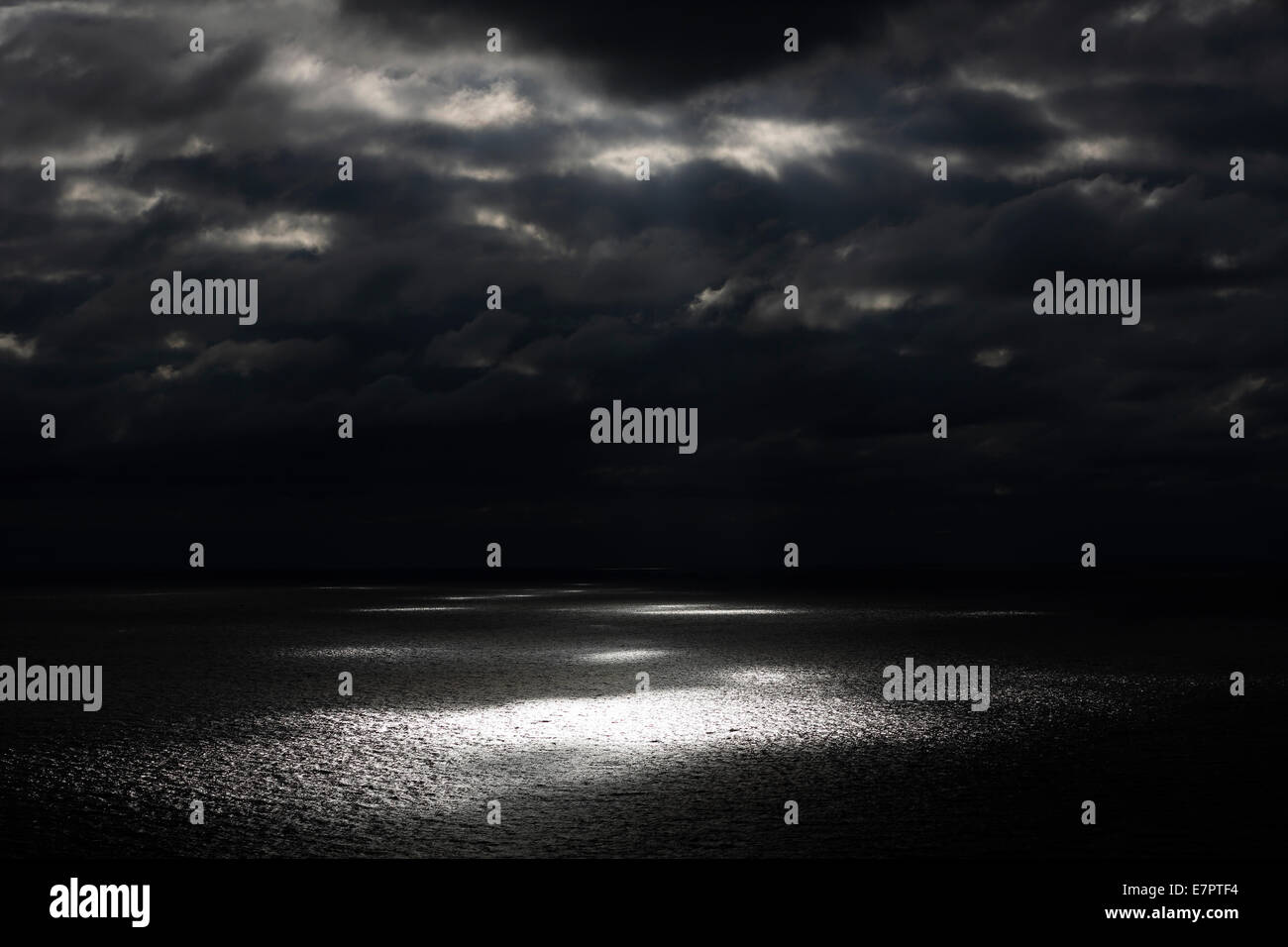 Sun shining through storm clouds hi-res stock photography and images ...