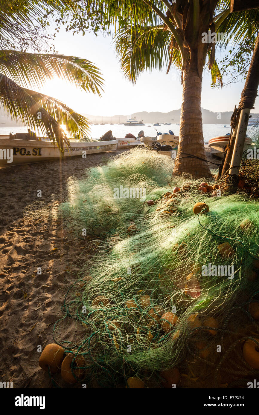 Fishing boats and nets on the beach at Zihuatanejo, Guerrero, Mexico ...