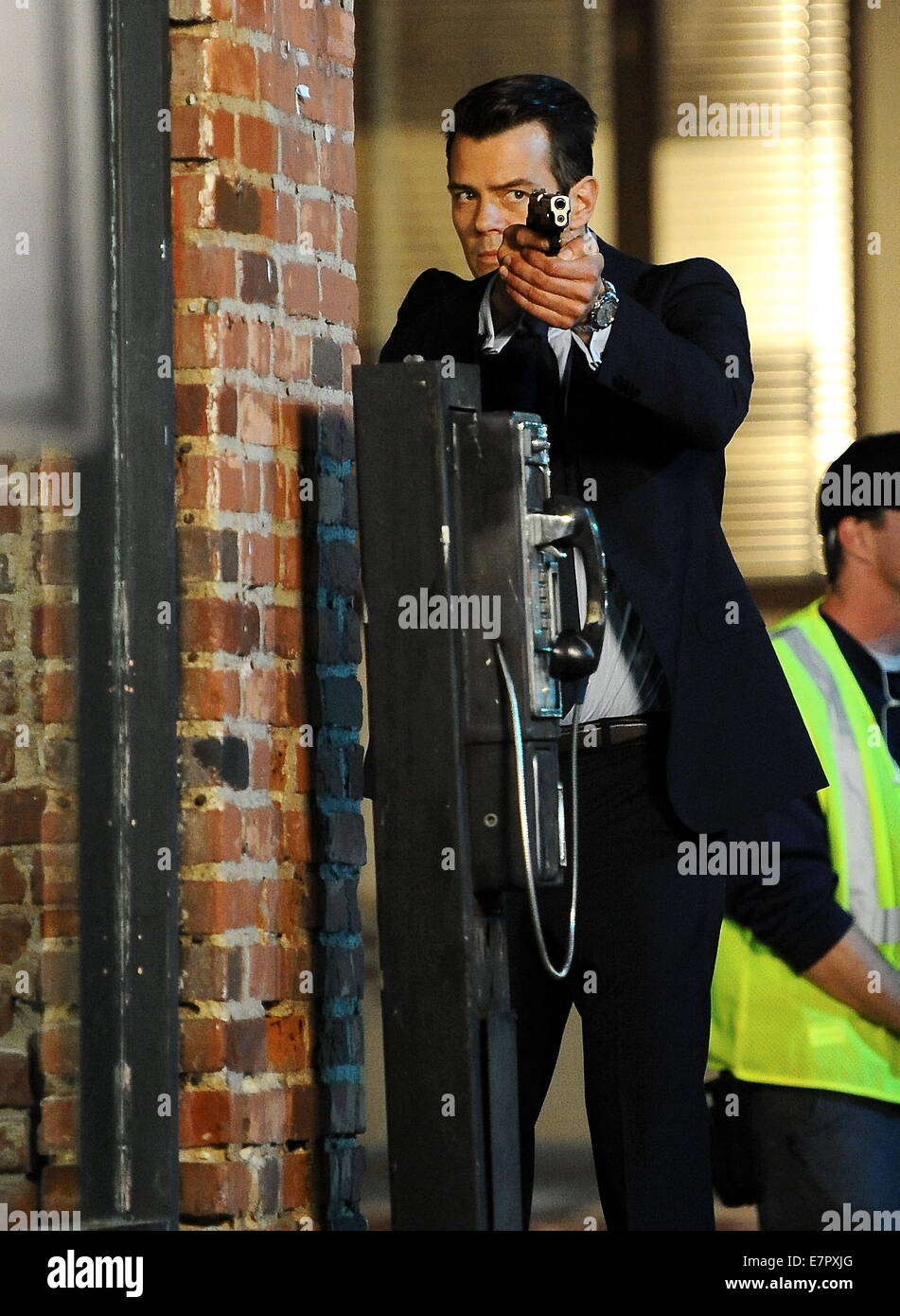 Josh Duhamel raises his gun at suspects on the set of his new show ...