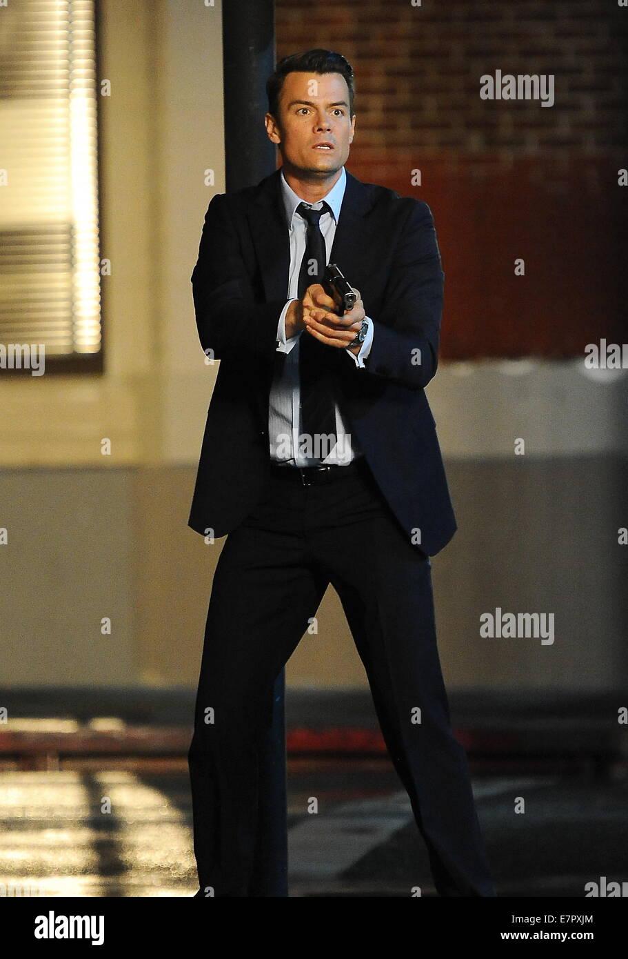 Josh Duhamel raises his gun at suspects on the set of his new show ...