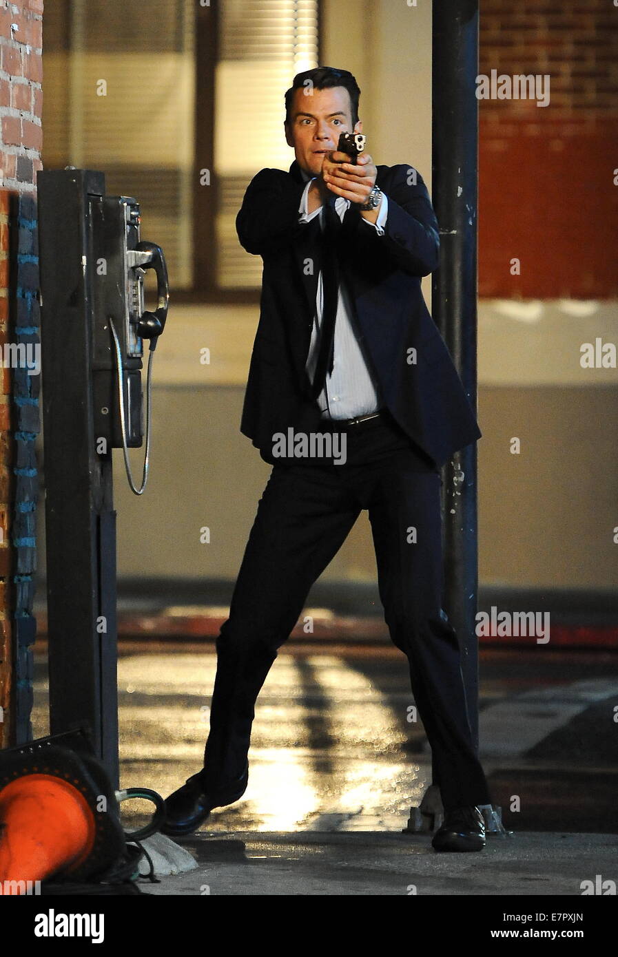 Josh Duhamel raises his gun at suspects on the set of his new show ...