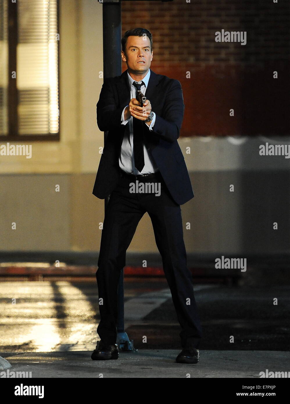 Josh Duhamel raises his gun at suspects on the set of his new show ...