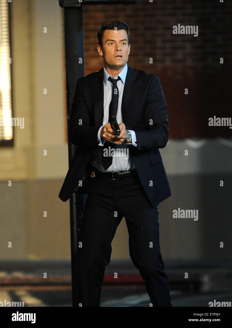 Josh Duhamel raises his gun at suspects on the set of his new show ...
