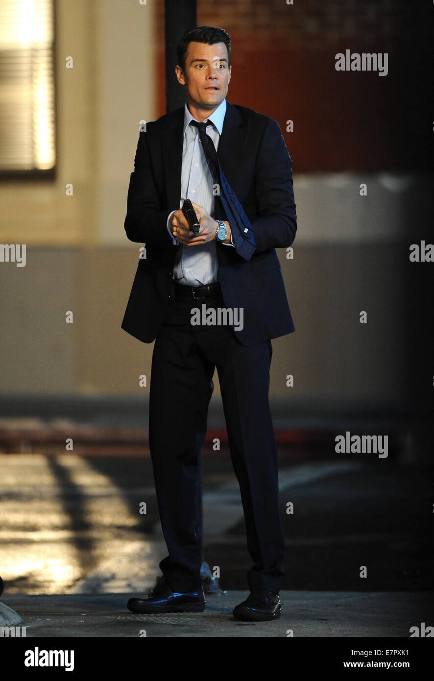 Josh Duhamel raises his gun at suspects on the set of his new show ...