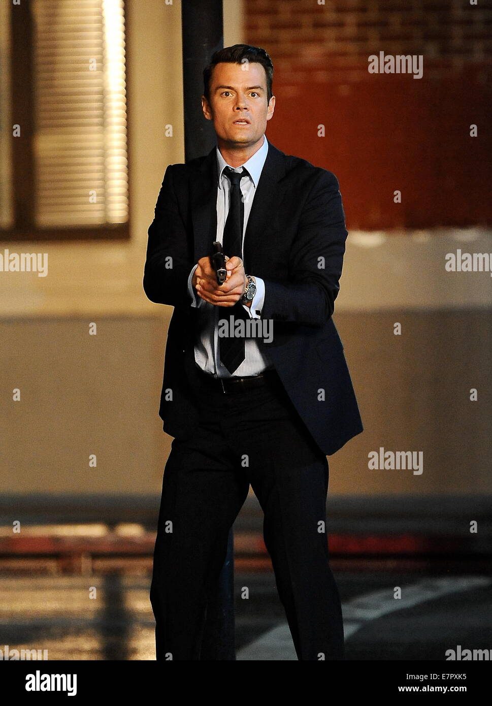 Josh Duhamel raises his gun at suspects on the set of his new show ...