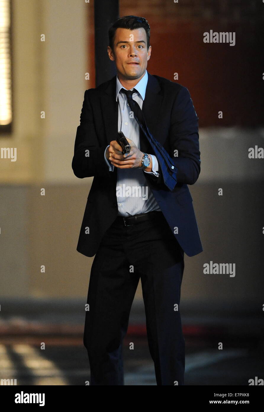 Josh Duhamel raises his gun at suspects on the set of his new show ...