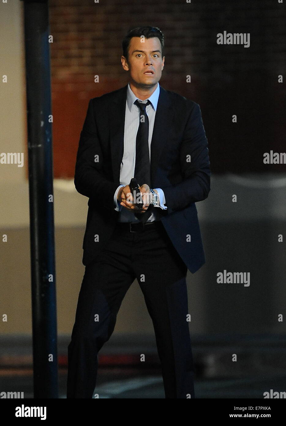 Josh Duhamel raises his gun at suspects on the set of his new show ...