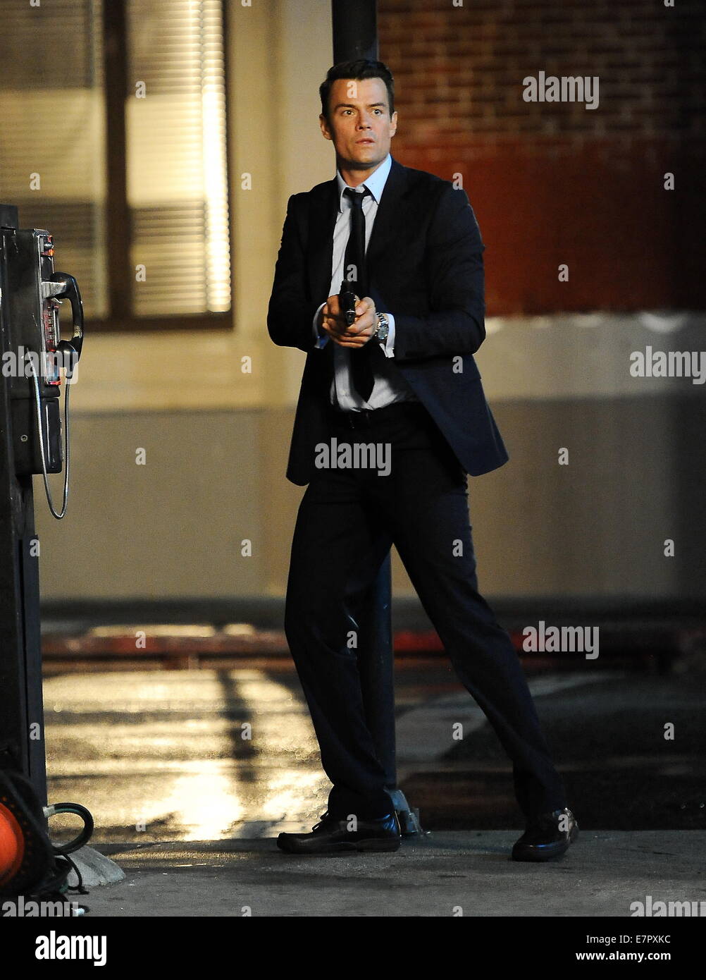 Josh Duhamel raises his gun at suspects on the set of his new show ...