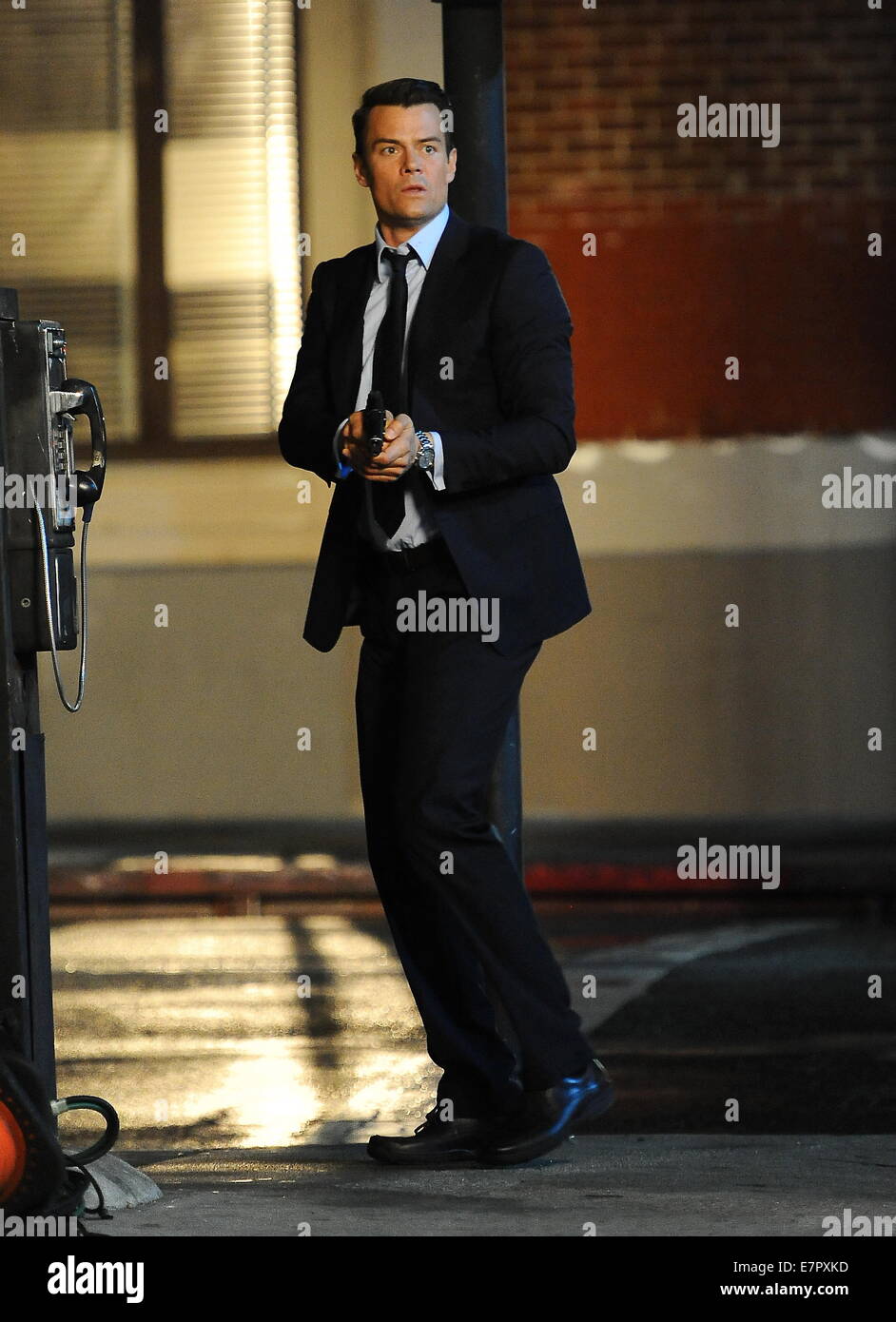 Josh Duhamel raises his gun at suspects on the set of his new show ...
